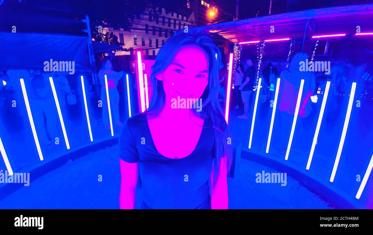Girl in pink and blue light, surrounded by neon lights pop art Stock ...