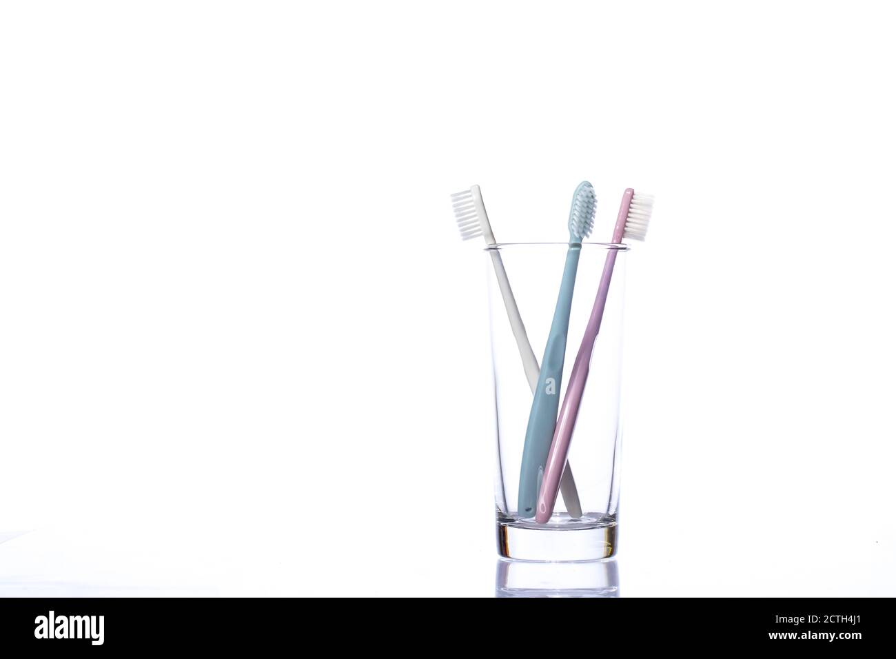 Toothbrushes in transparent glass isolated on white background, dental ...