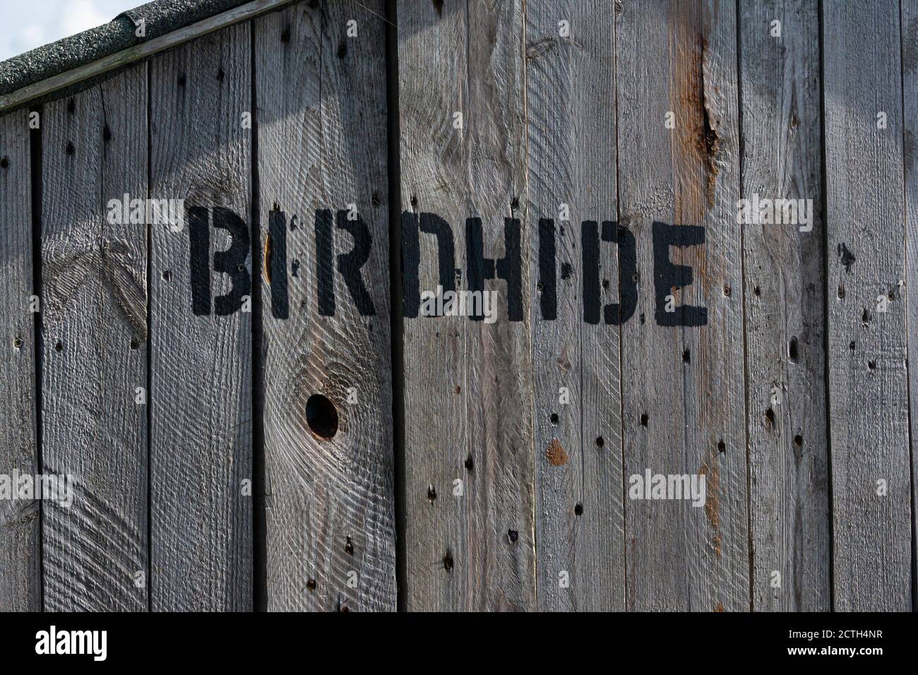 Bird hide stencilled on the side of a wooden bird hide on St Martin's ...