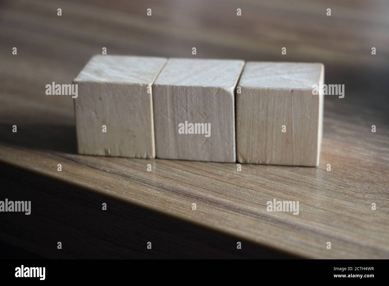 Three Wooden Blocks Front View, On Wooden Table border. Education ...