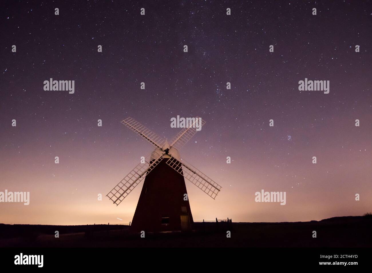 Halnaker windmill silhouetted against the night sky full of stars ...