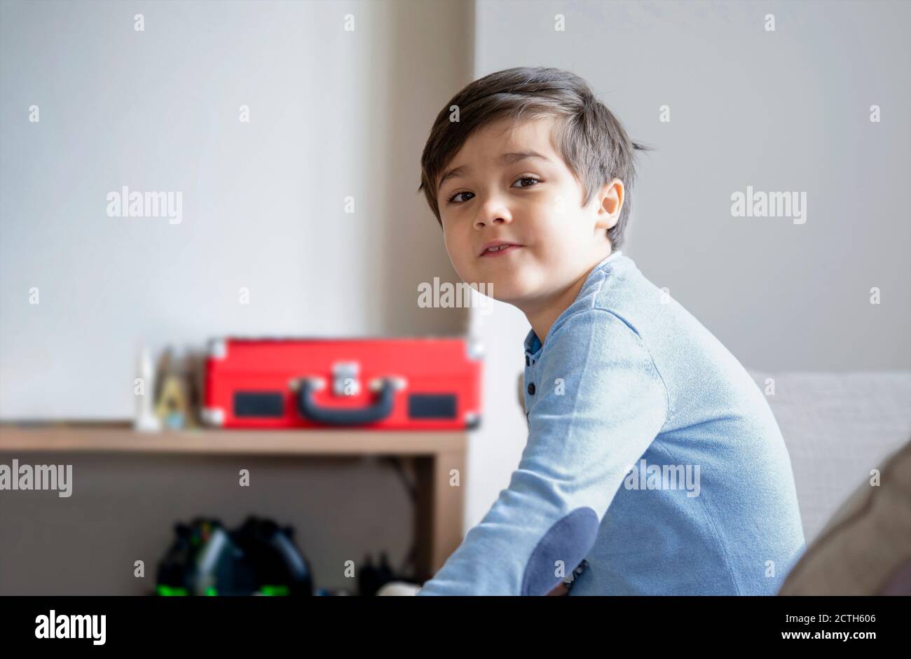Portrait happy kid playing alone in living room, New normal life stlye ...