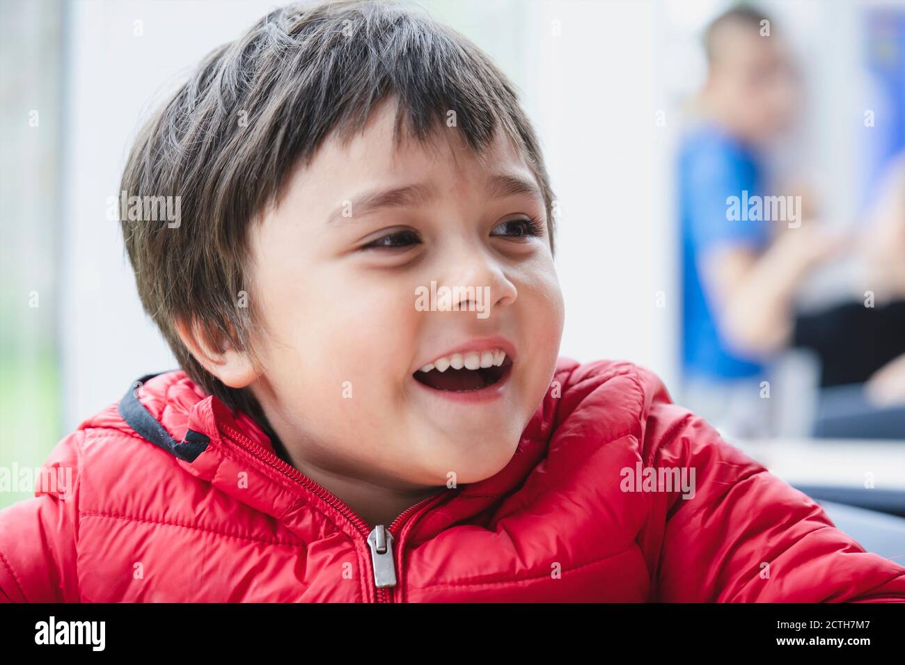 Selective focus side view kid looking out with smiling face, Snap shot ...