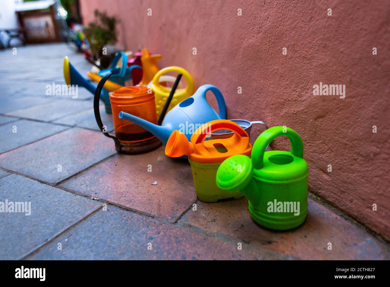 Set of multi-colored plastic watering cans for garden care Stock Photo ...