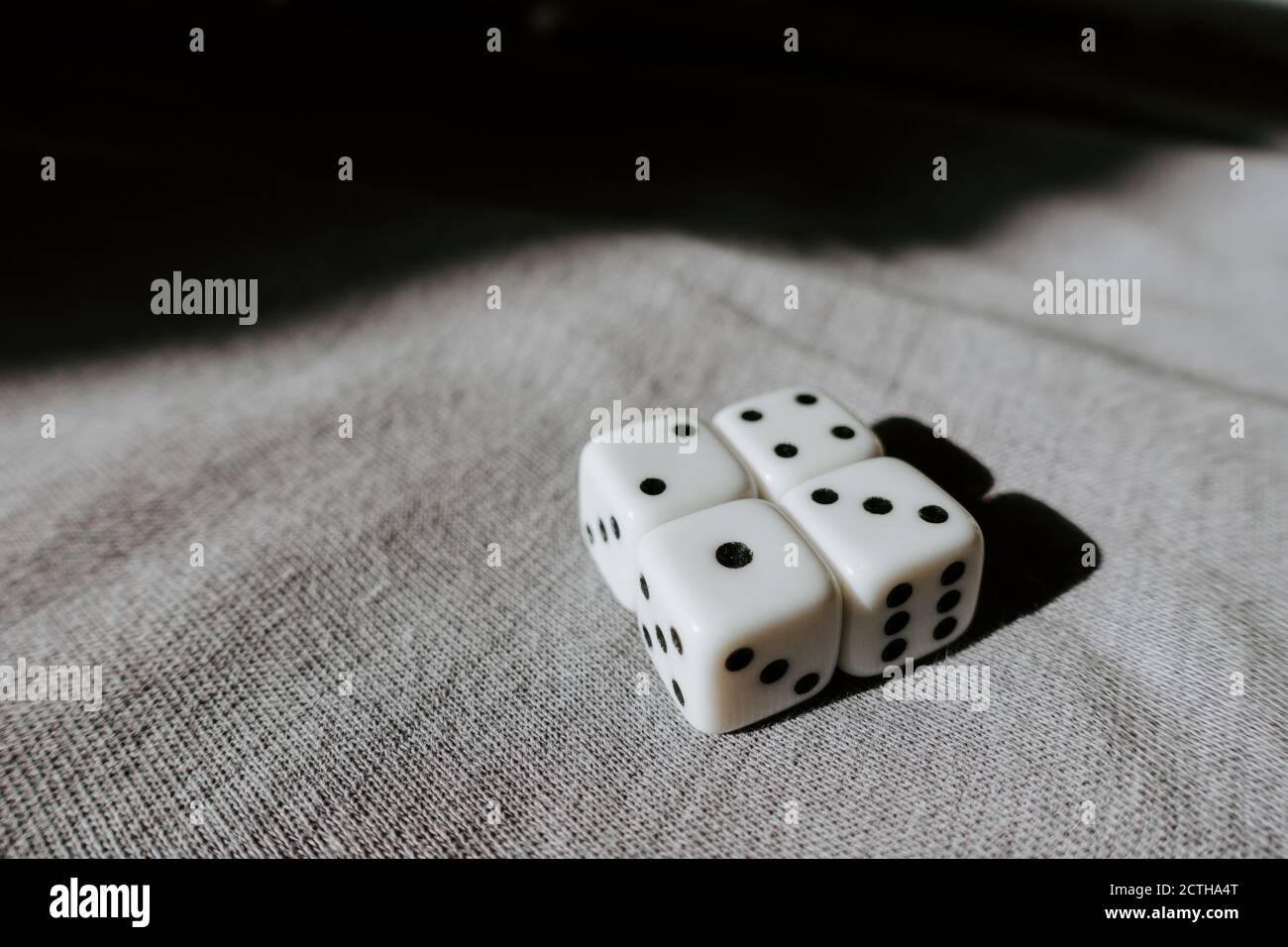 Four dice showing consecutive numbers on a grey background Stock Photo ...