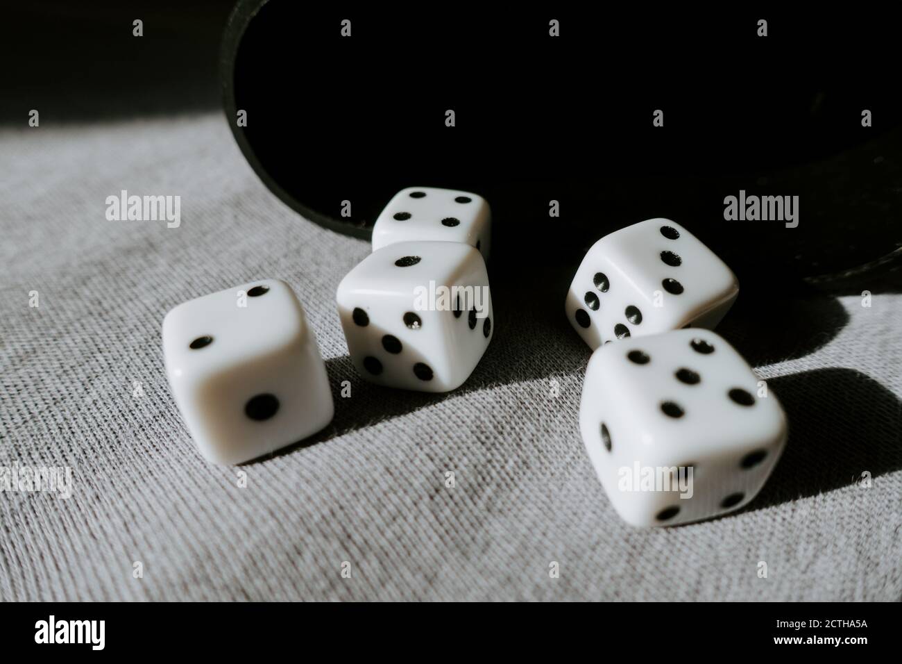 Five dice with different numbers and cup in the background Stock Photo ...