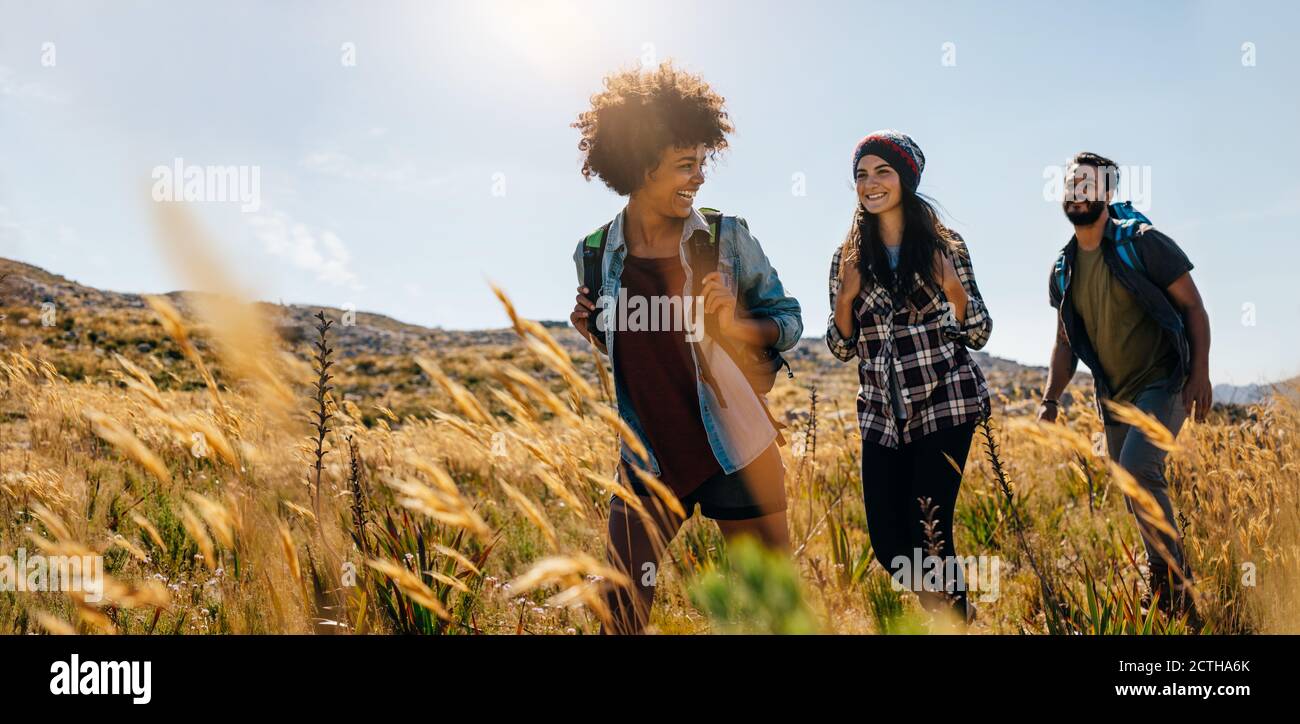 Group of friends on country walk. Young people hiking in countryside ...