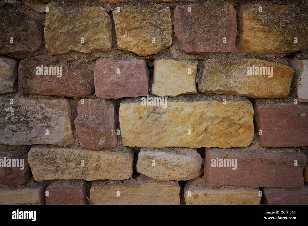 Background stone wall made of red stones Stock Photo - Alamy