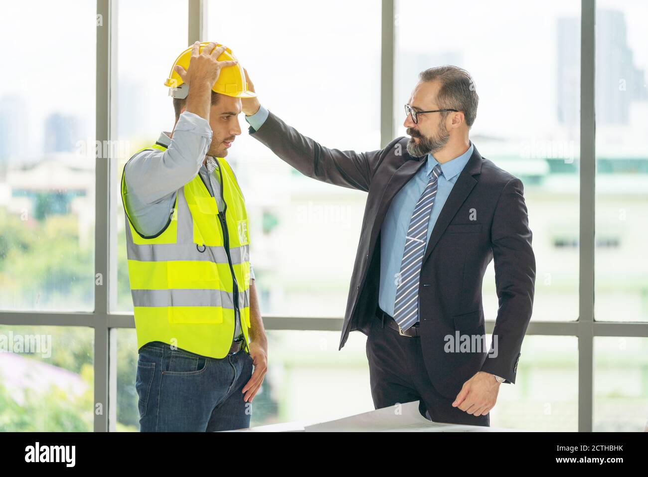 businessman wearing hard safety helmet hat for safety project of ...