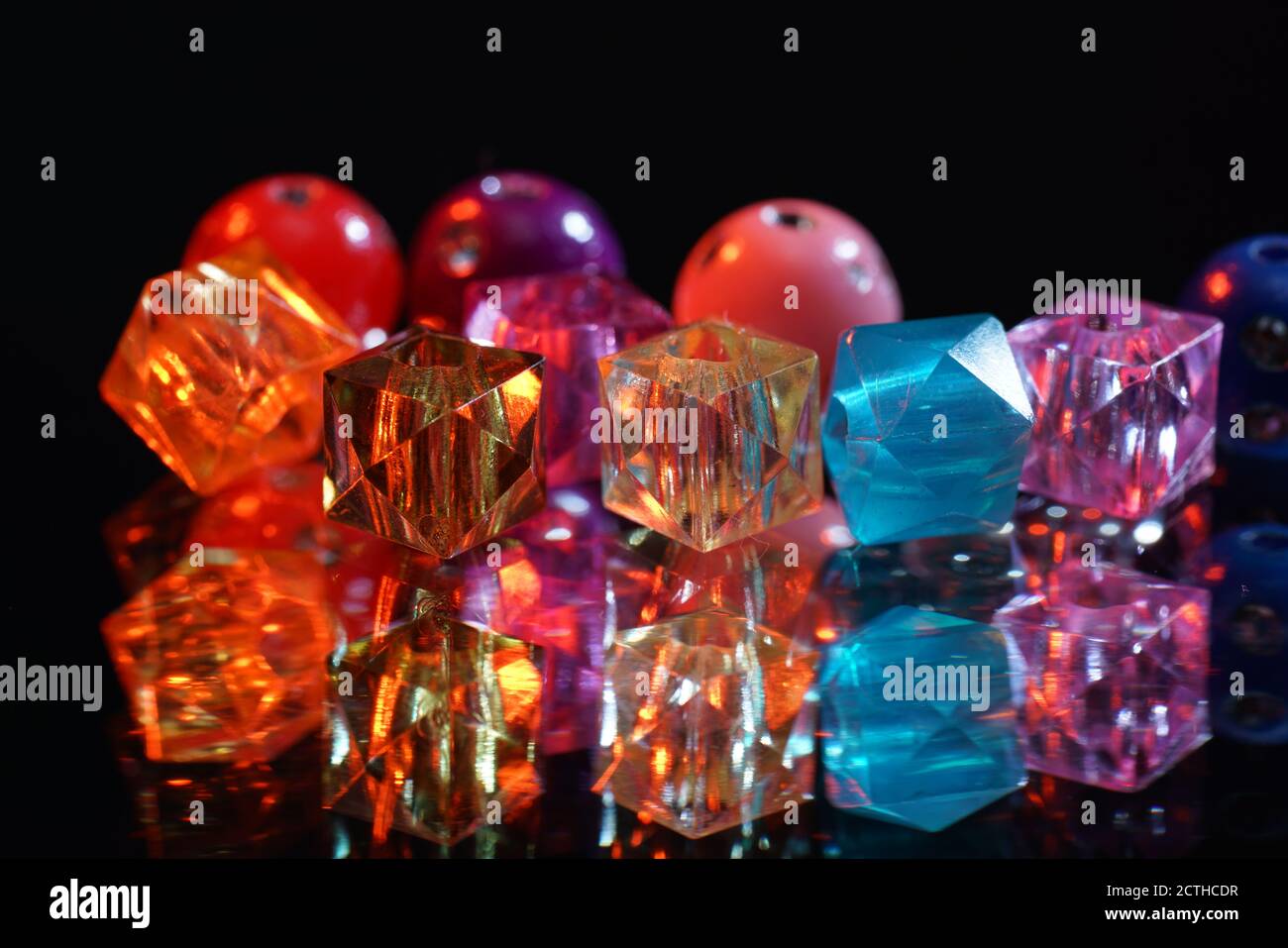 Colorful glass beads on mirrored surface photographed in studio Stock ...
