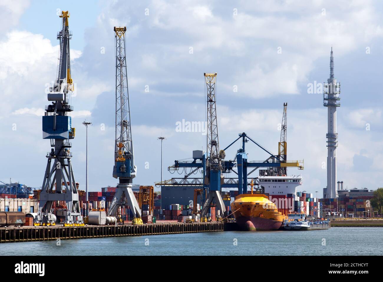ROTTERDAM - Cargo ship and cranes in the harbour Stock Photo - Alamy