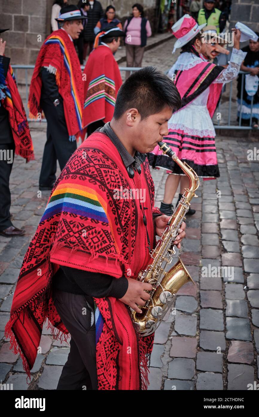 A saxophonist in a marching band in colourful colorful costume during ...