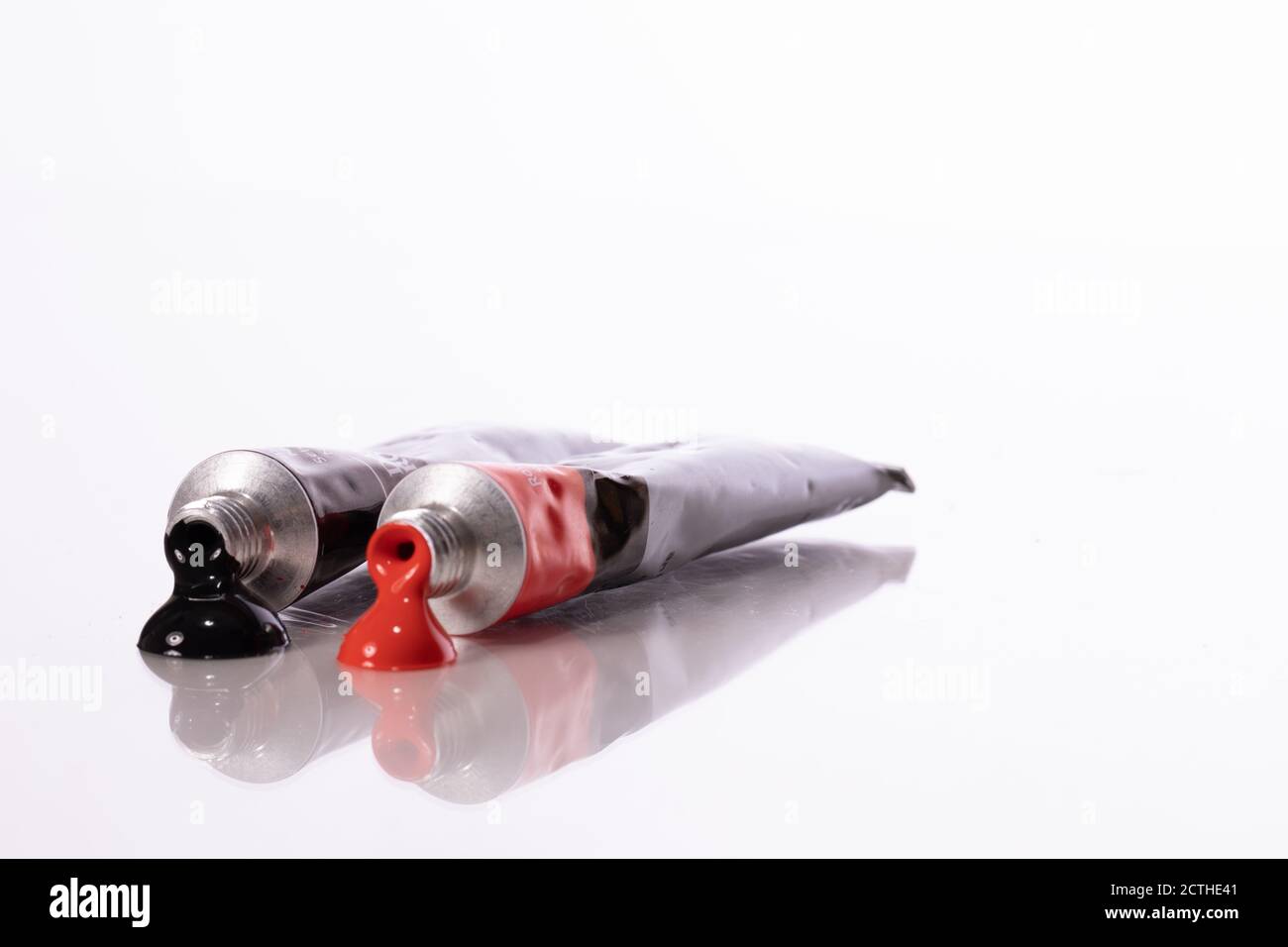 Set of red and black acrylic paint tubes isolated on white background ...