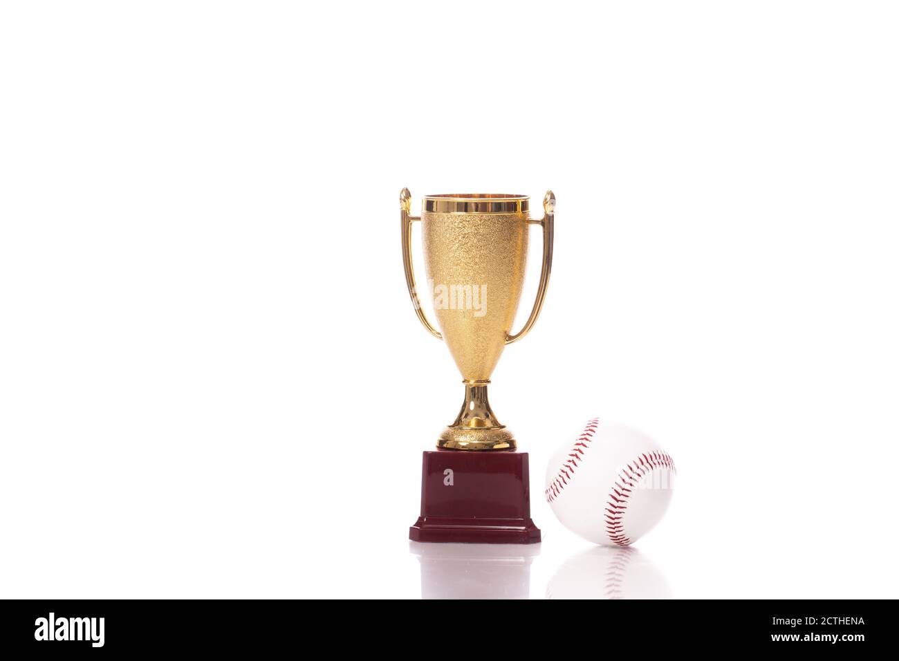 Small golden trophy cup and baseball ball isolated on white background ...