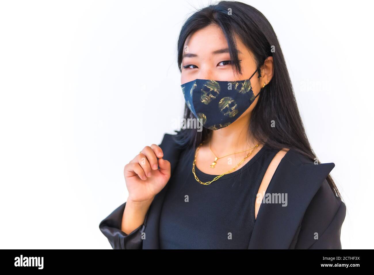 Young Asian woman wearing a face mask with skulls Stock Photo - Alamy