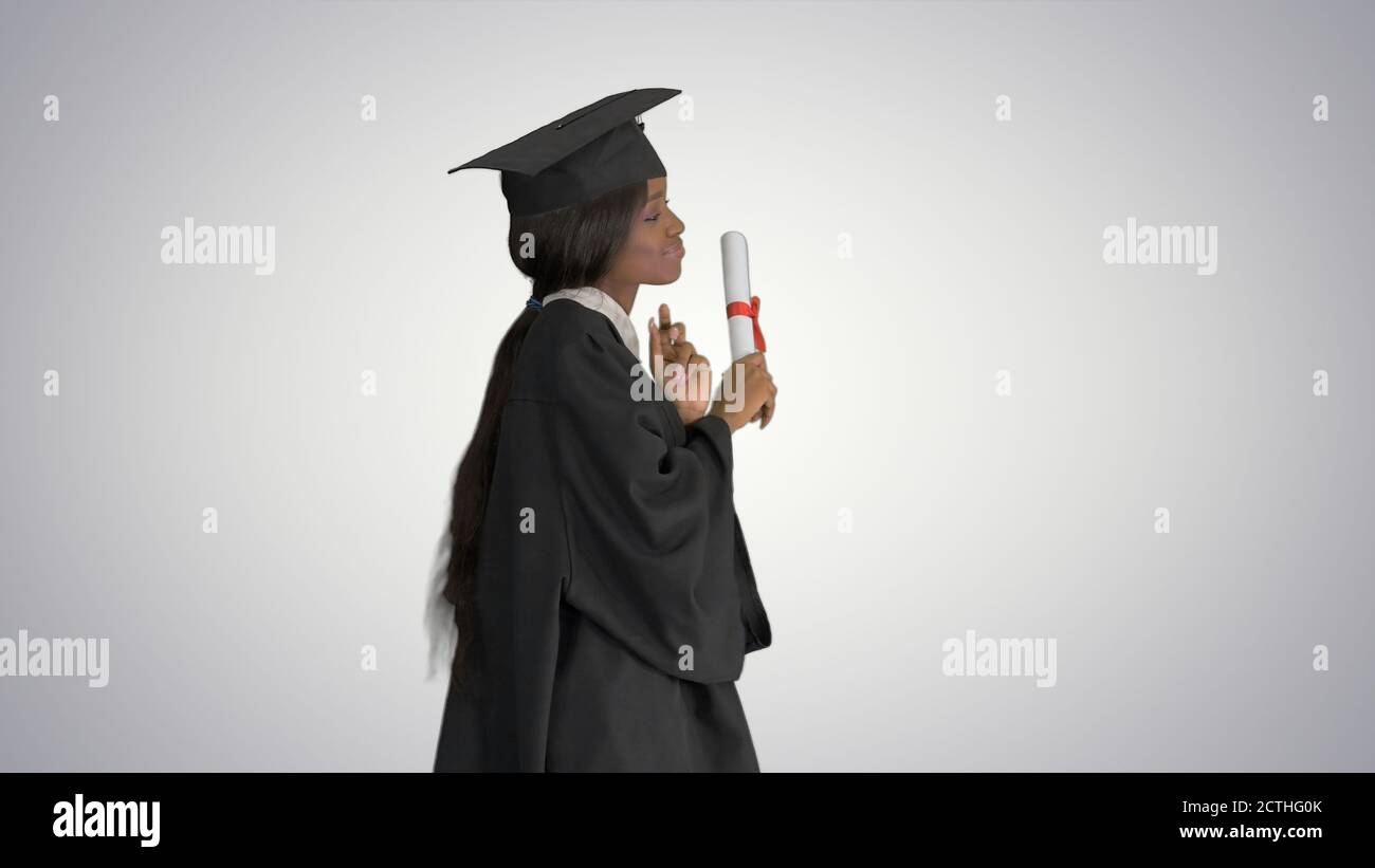 Happy African American female graduate dancing with her diploma Stock ...