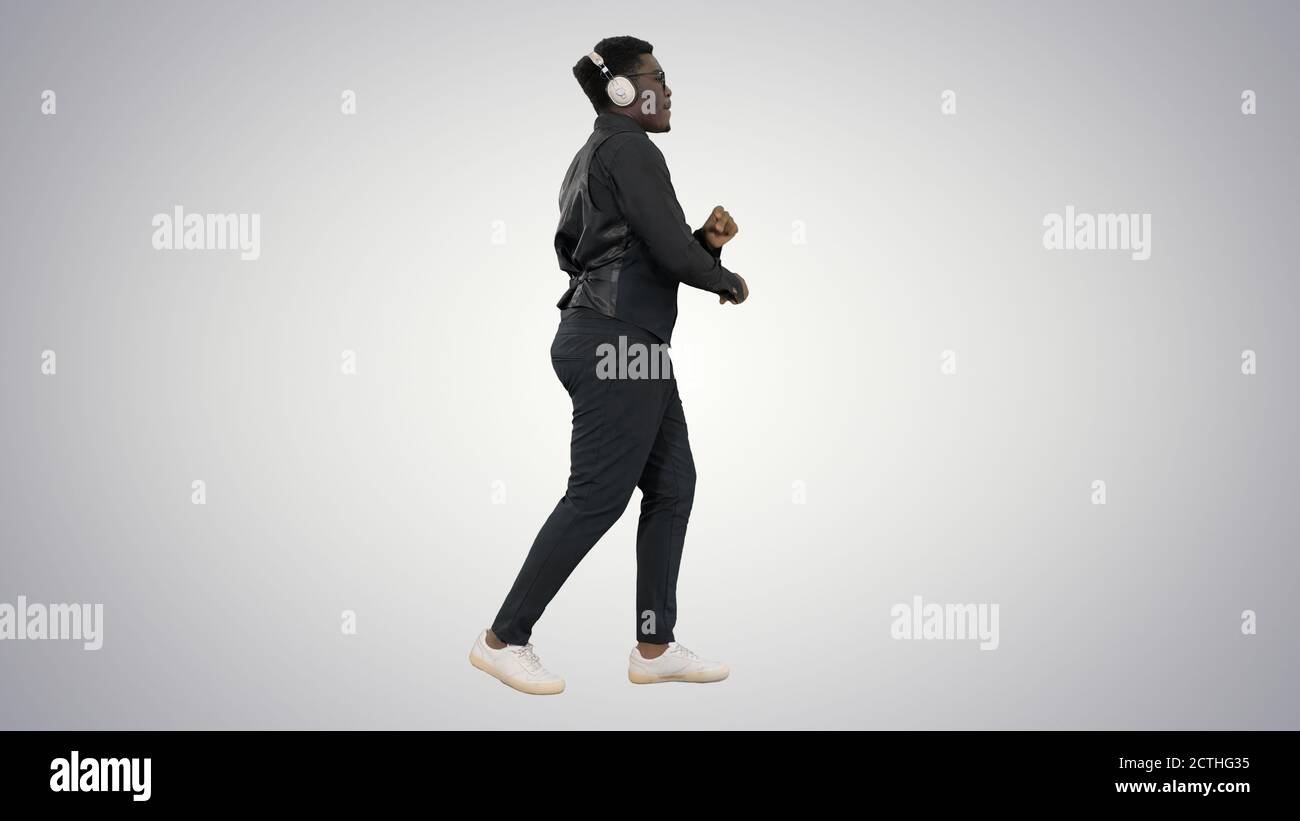 Guy listening to music and dancing while walking on gradient bac Stock ...