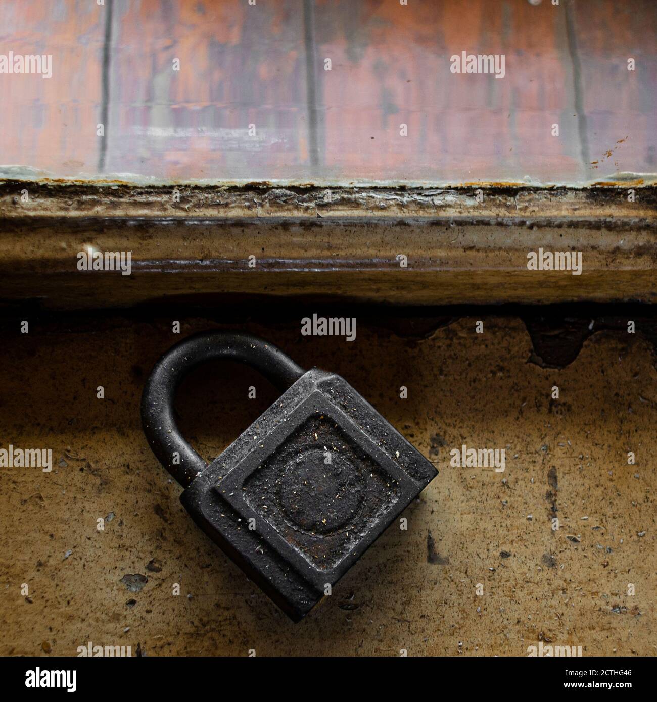 An old padlock lies on an old dirty window sill Stock Photo - Alamy