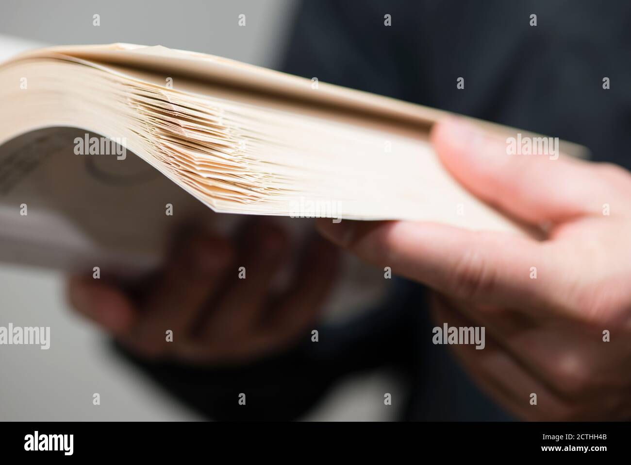 Detail of man reading a book with dogears bookmarks Stock Photo - Alamy