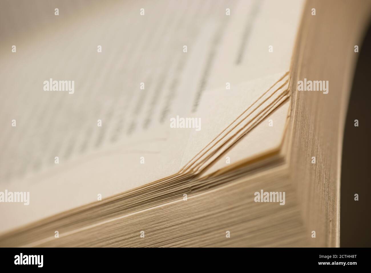 Detail of open book with dog-ears bookmarks Stock Photo - Alamy