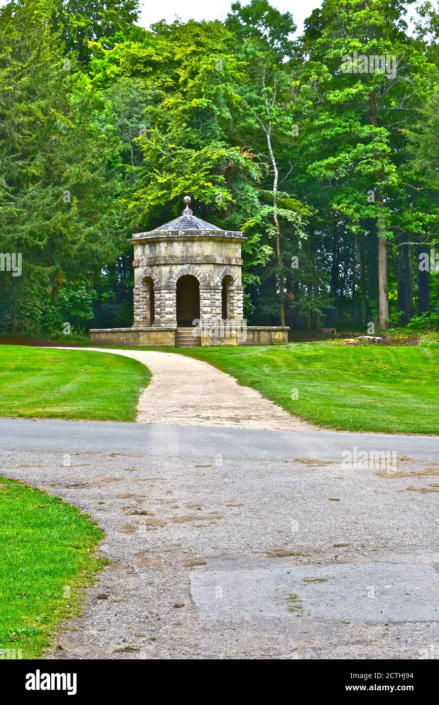 Old stone folly building in the grounds of Cirencester Park, part of ...