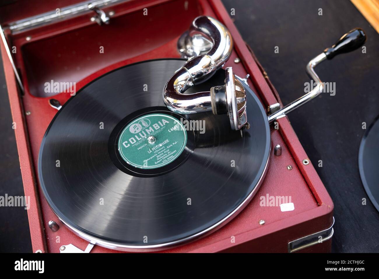 Old retro Gramophone in red case with vinyl playing on an antique ...
