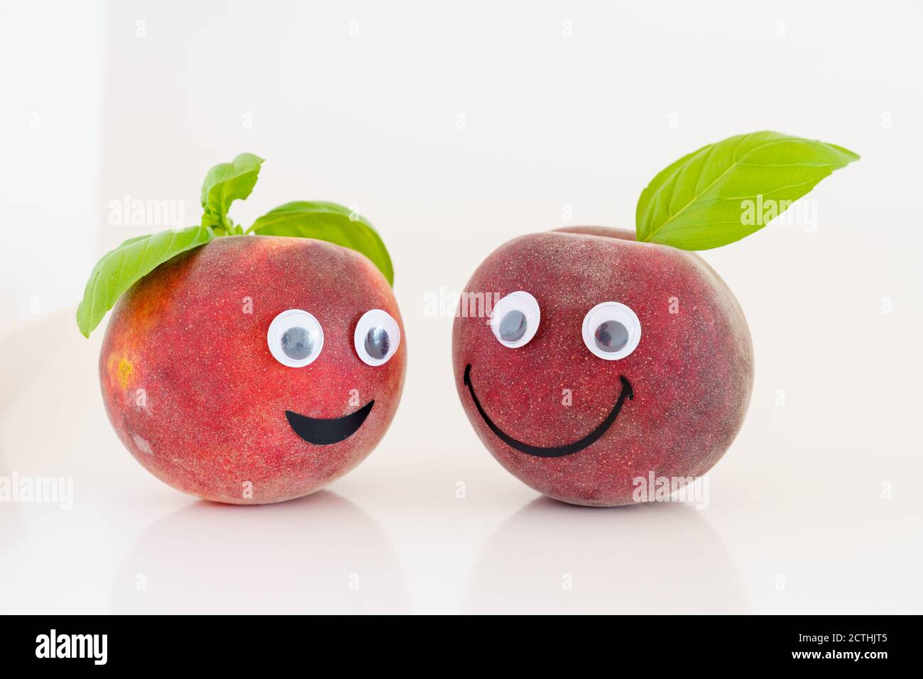 Fruit with a smile and eyes. Smiling peach Stock Photo - Alamy