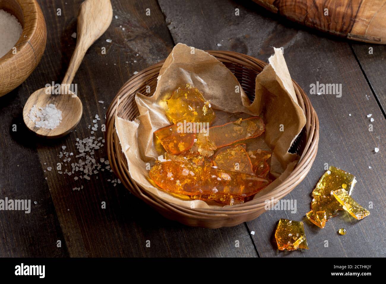 Salted caramel candy shards in a wicker basket Stock Photo - Alamy