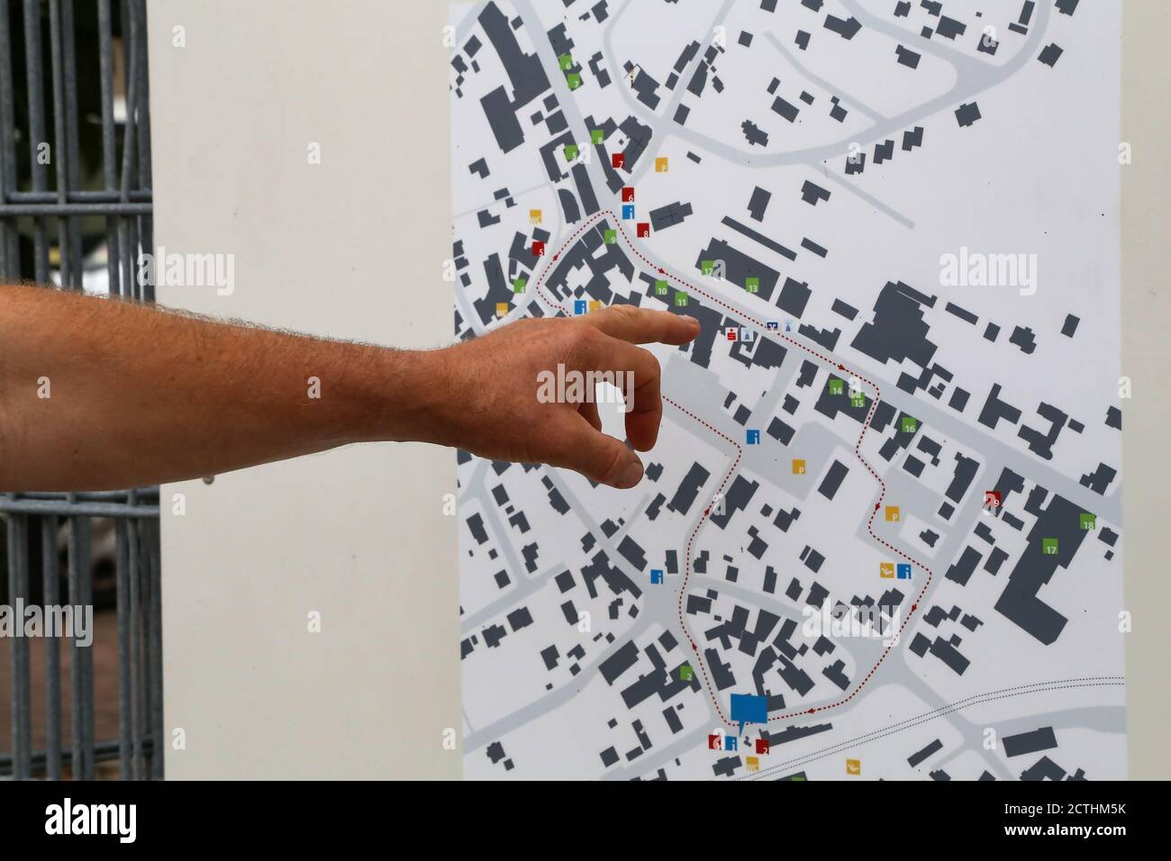 Hand showing direction on the city map Stock Photo - Alamy