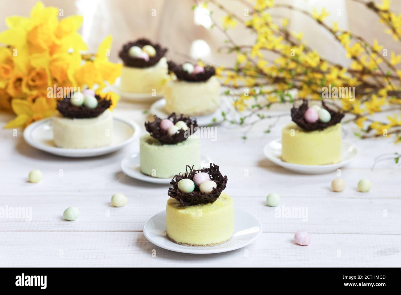 Easter pastel mousse desserts and spring flowers Stock Photo - Alamy