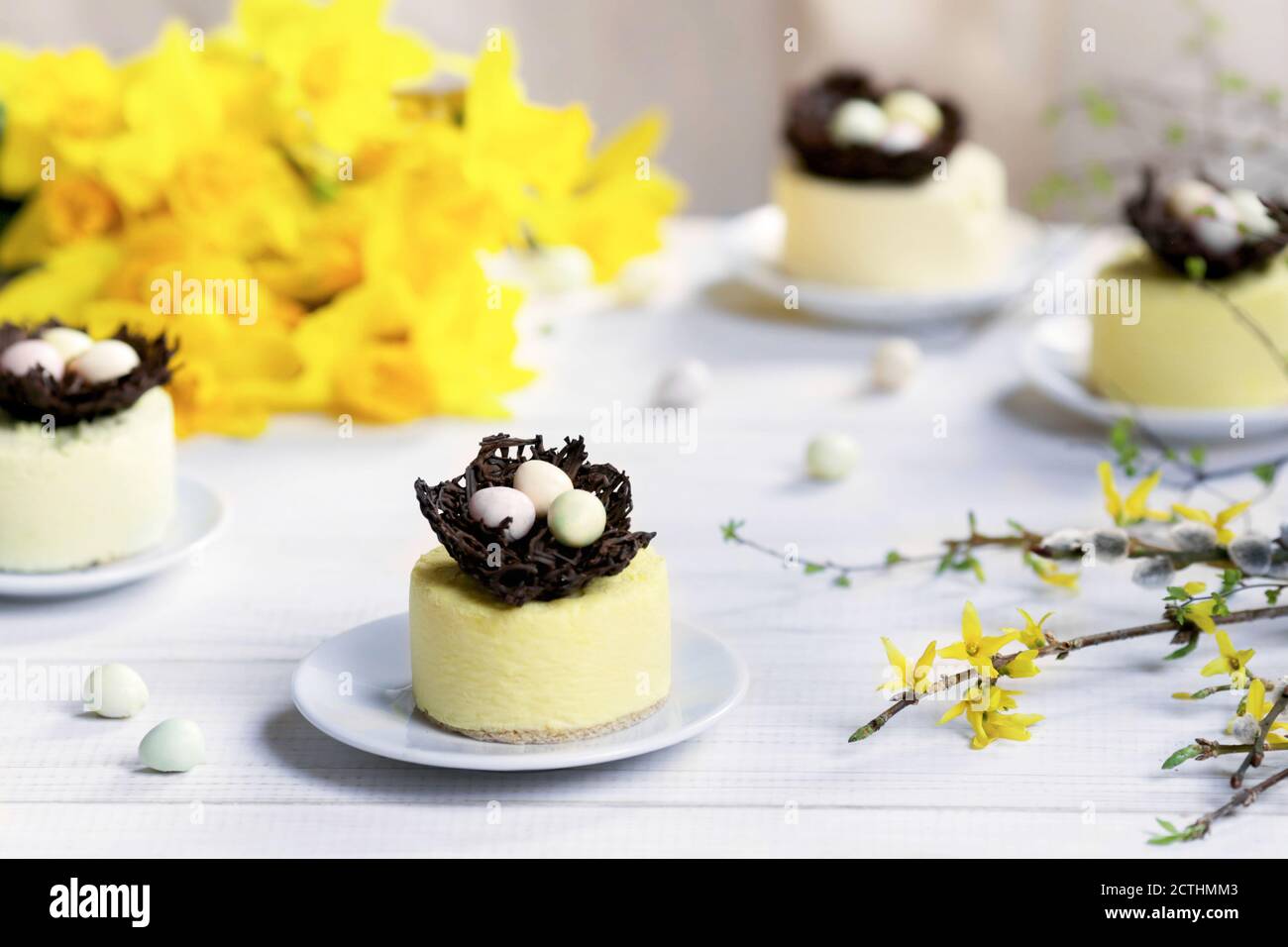 Easter pastel mousse desserts and spring flowers Stock Photo - Alamy