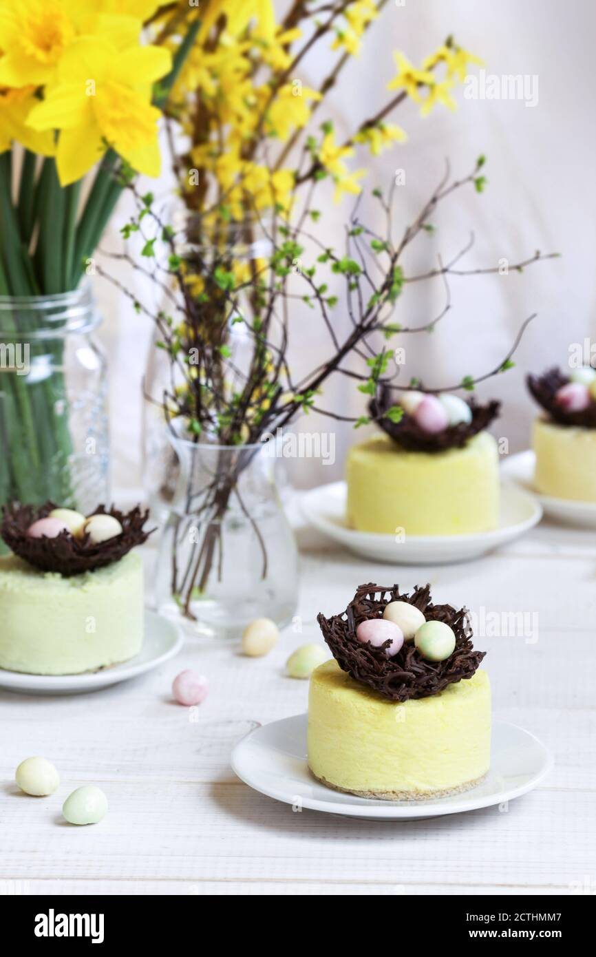 Easter pastel mousse desserts and spring flowers Stock Photo - Alamy