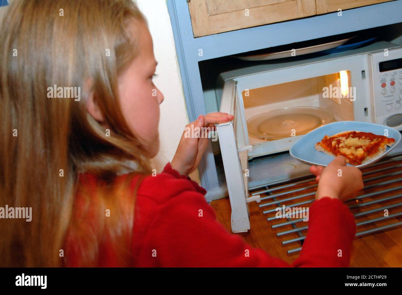 girl heats up her microwave meal Stock Photo - Alamy