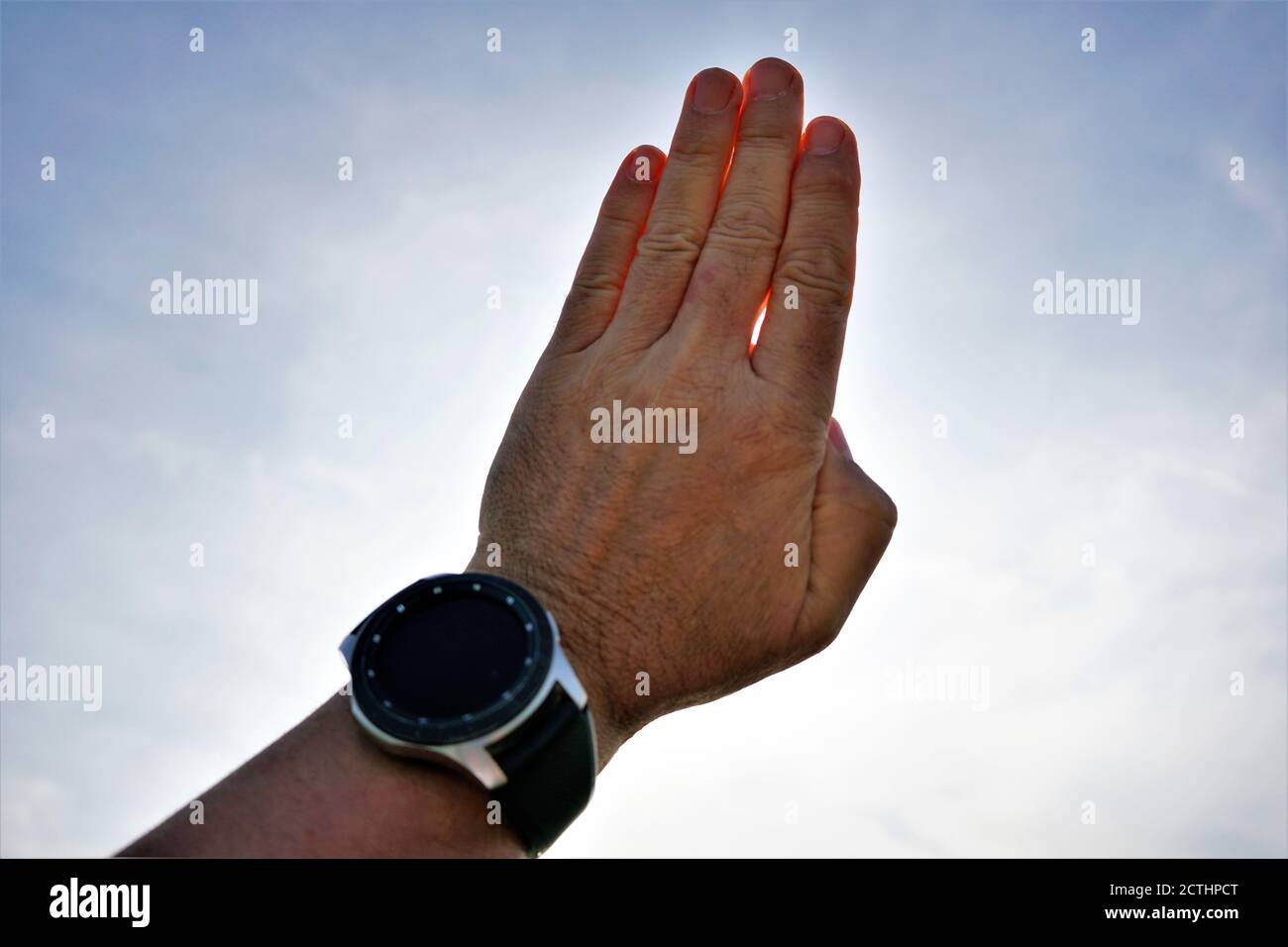 Simple concept of a man's hand with smartwatch and sun-rays passing ...