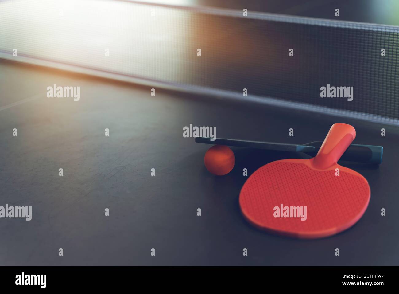 Ping pong table, rackets and ball in a sport hall Stock Photo - Alamy