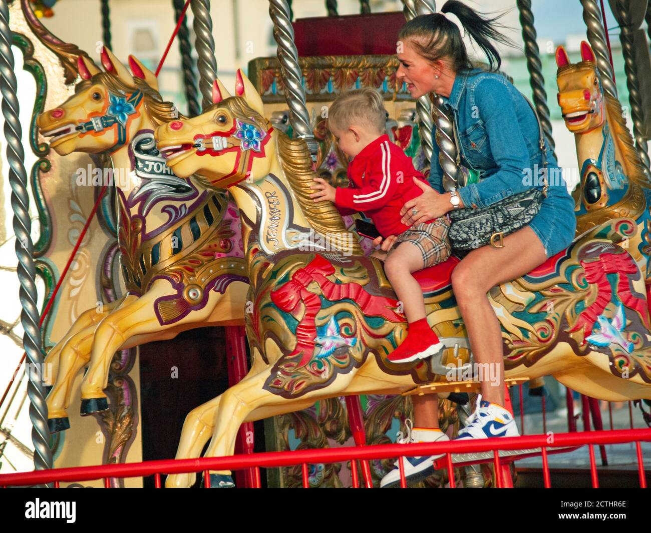 Riding the carousel on the seafront at Brighton Stock Photo - Alamy