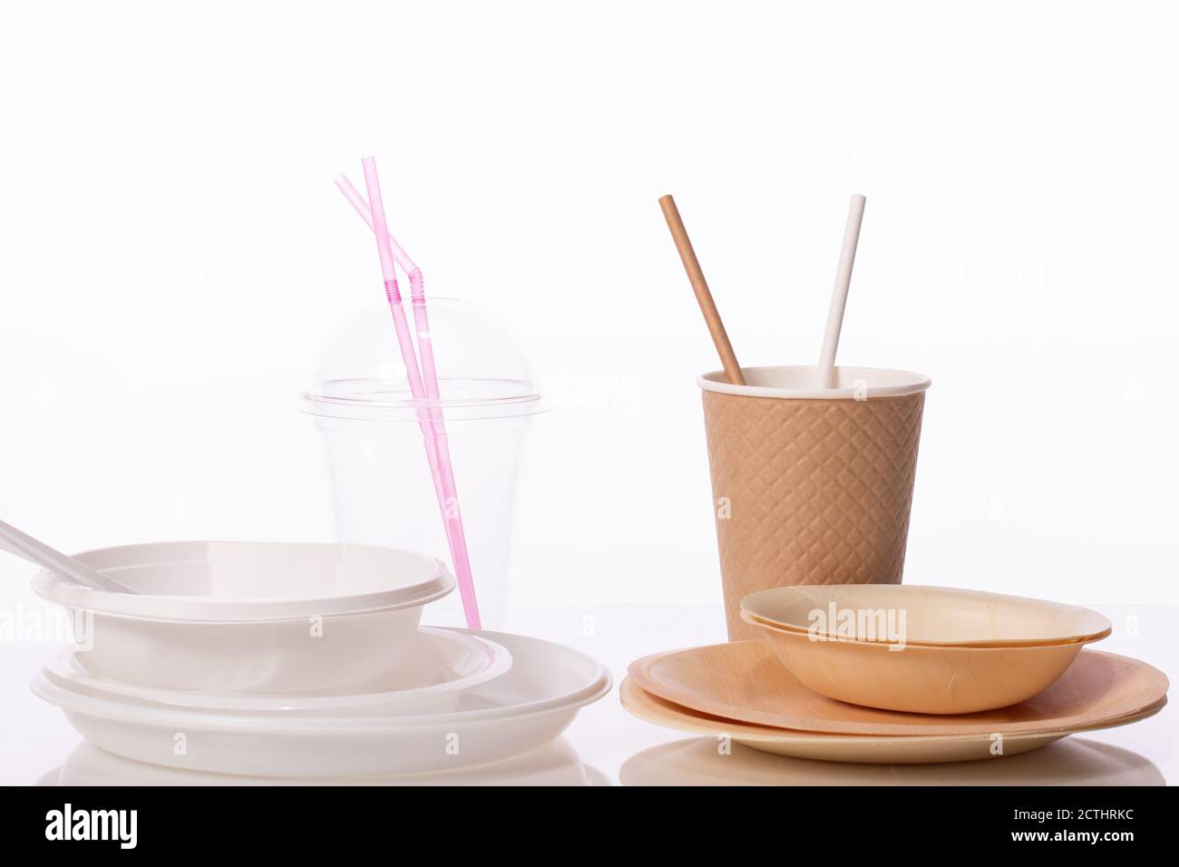 Plastic vs natural materials. Plastic dinnerware against craft paper ...