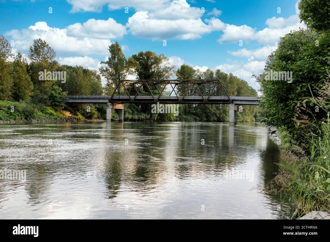 Railroad bridge over large river Stock Photo - Alamy