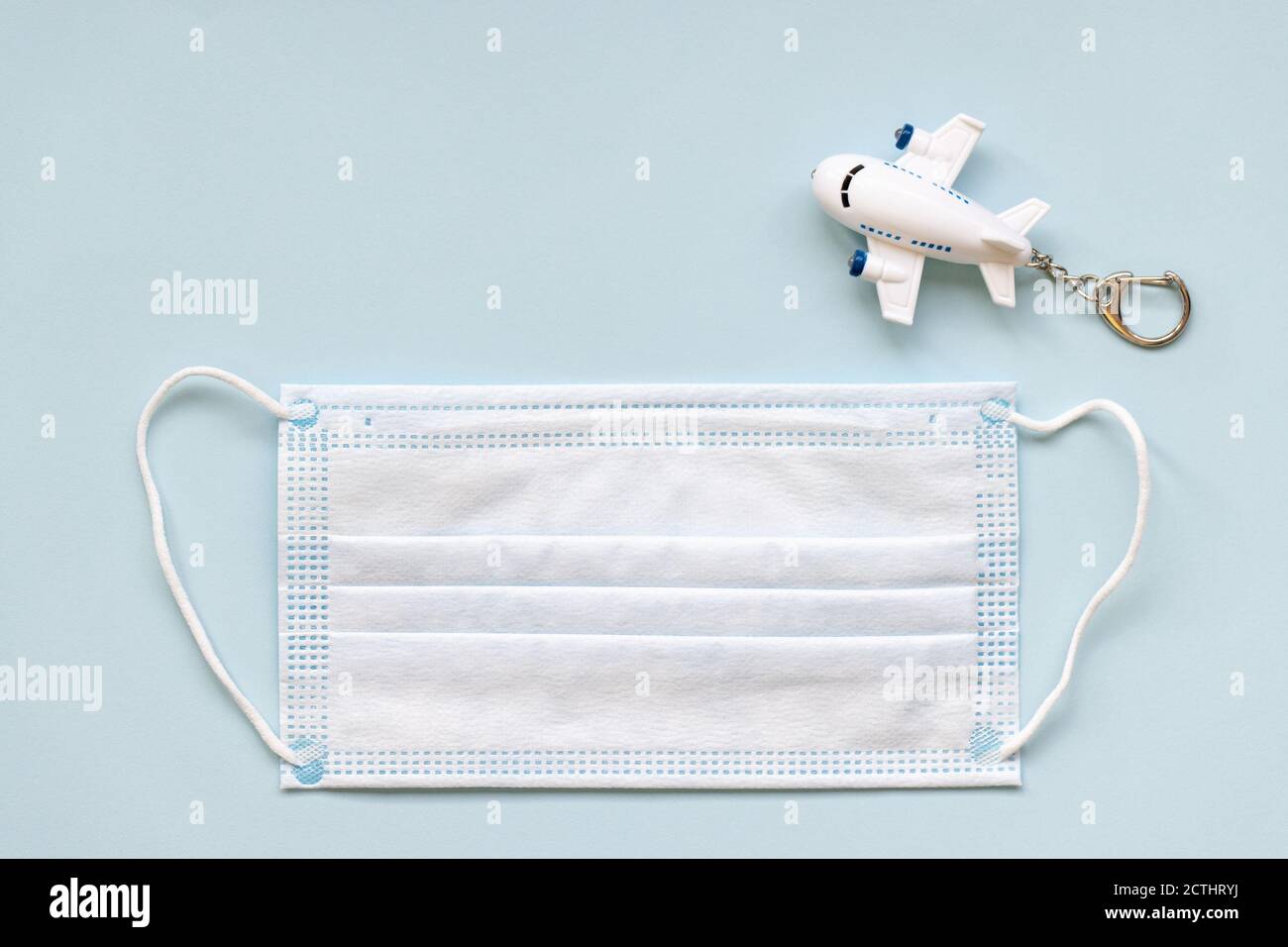 White surgical face mask and airplane on blue Stock Photo - Alamy