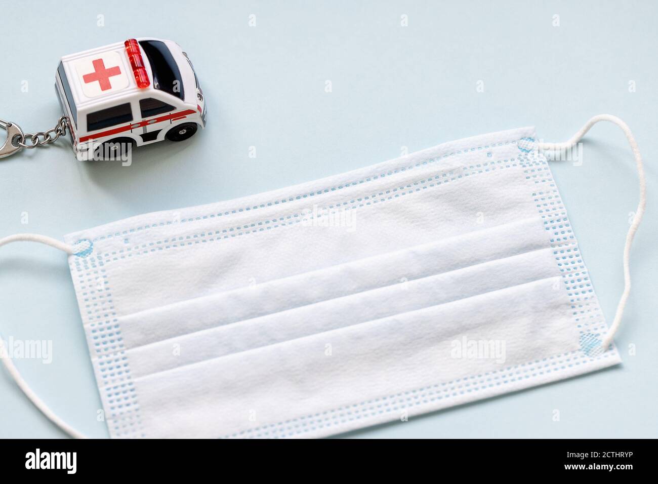 White surgical face mask and ambulance car on blue Stock Photo - Alamy