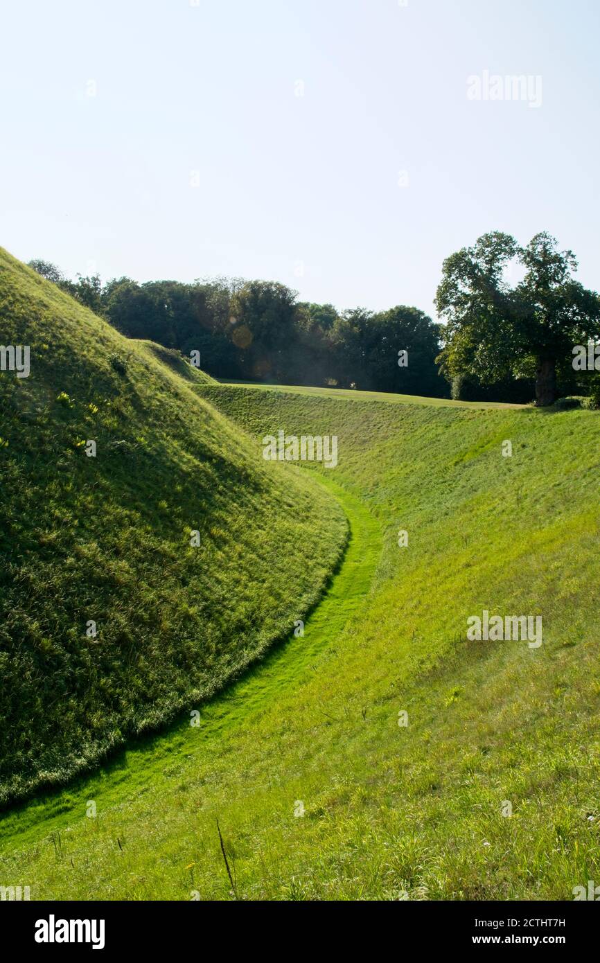 Castle Rising showing defensive moat now dry and grassed over. Portrait ...