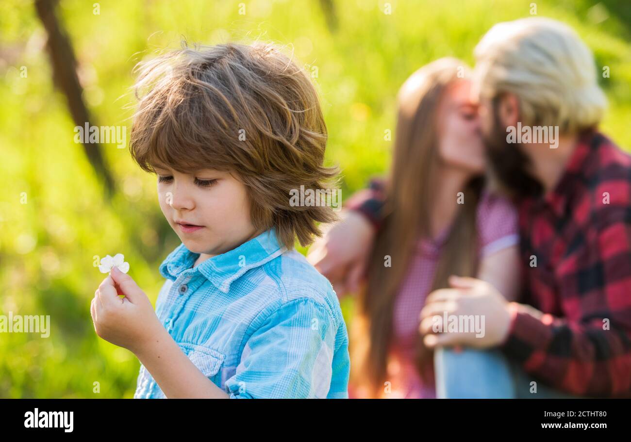 Pledge of love. Little child with couple kissing on background. Small ...