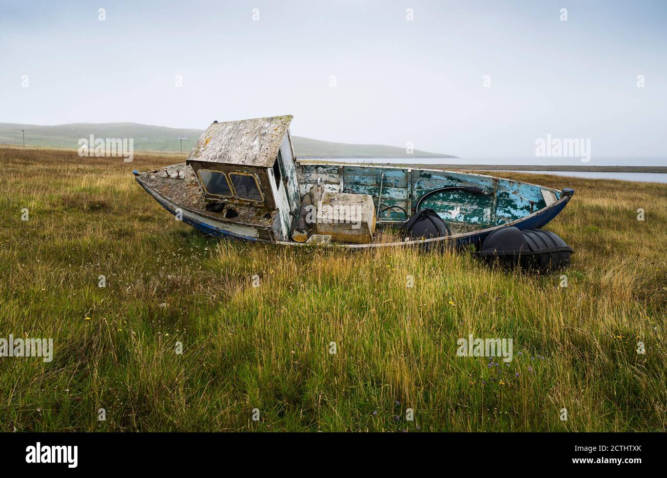 Old fishing boat abandoned in a field at North Roe village, North Roe ...
