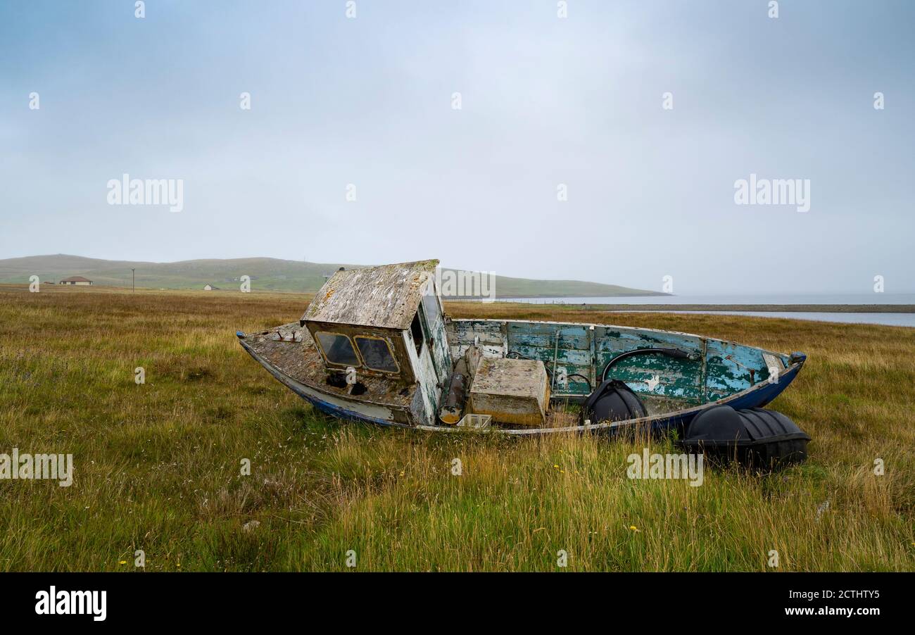Old fishing boat abandoned in a field at North Roe village, North Roe ...