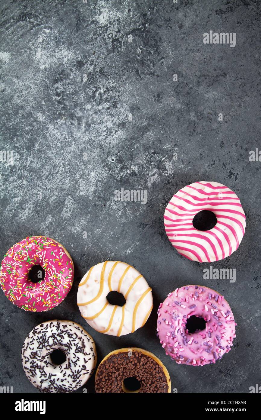 Baked sweet delicious donuts with pastry crumb on gray concrete ...