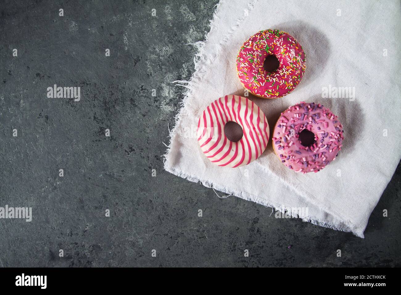 Baked sweet delicious donuts with pastry crumb on gray concrete ...