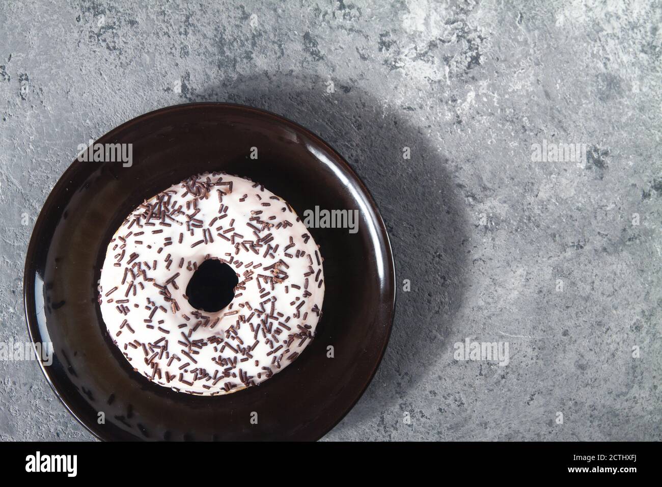 Baked sweet delicious donuts with pastry crumb on gray concrete ...