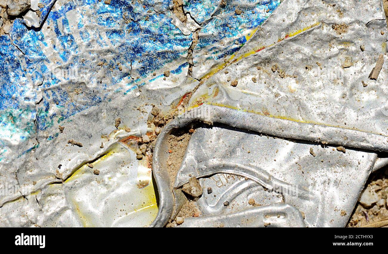 Detail of a flat crushed can lying on a motorway Stock Photo - Alamy