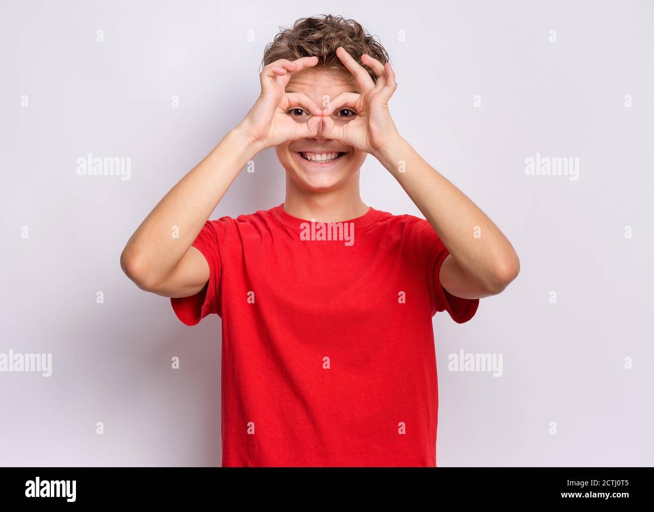 Portrait of handsome teen boy making Ok Gesture with hand on eyes ...
