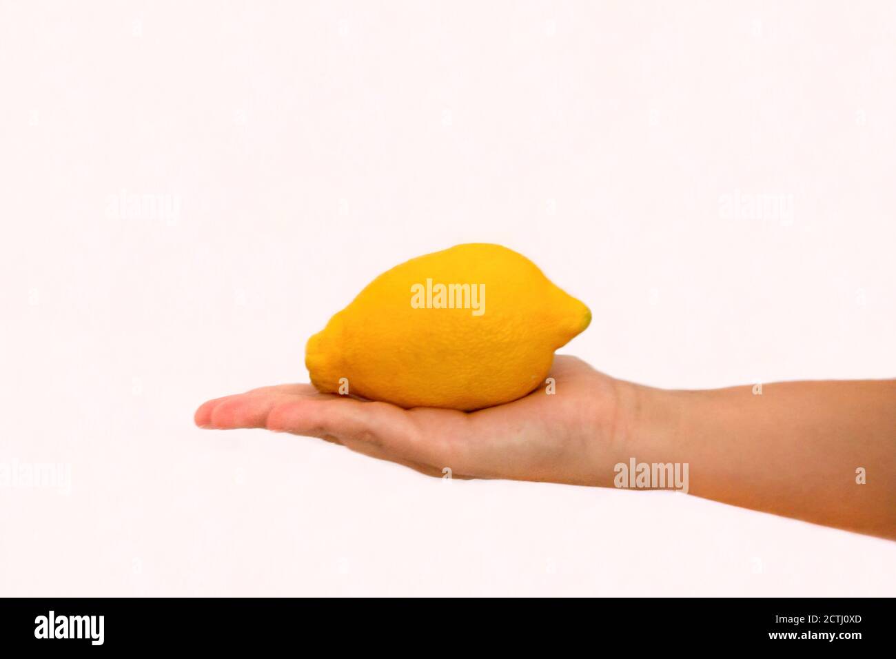 Women Hand Holding a Lemon Stock Photo - Alamy